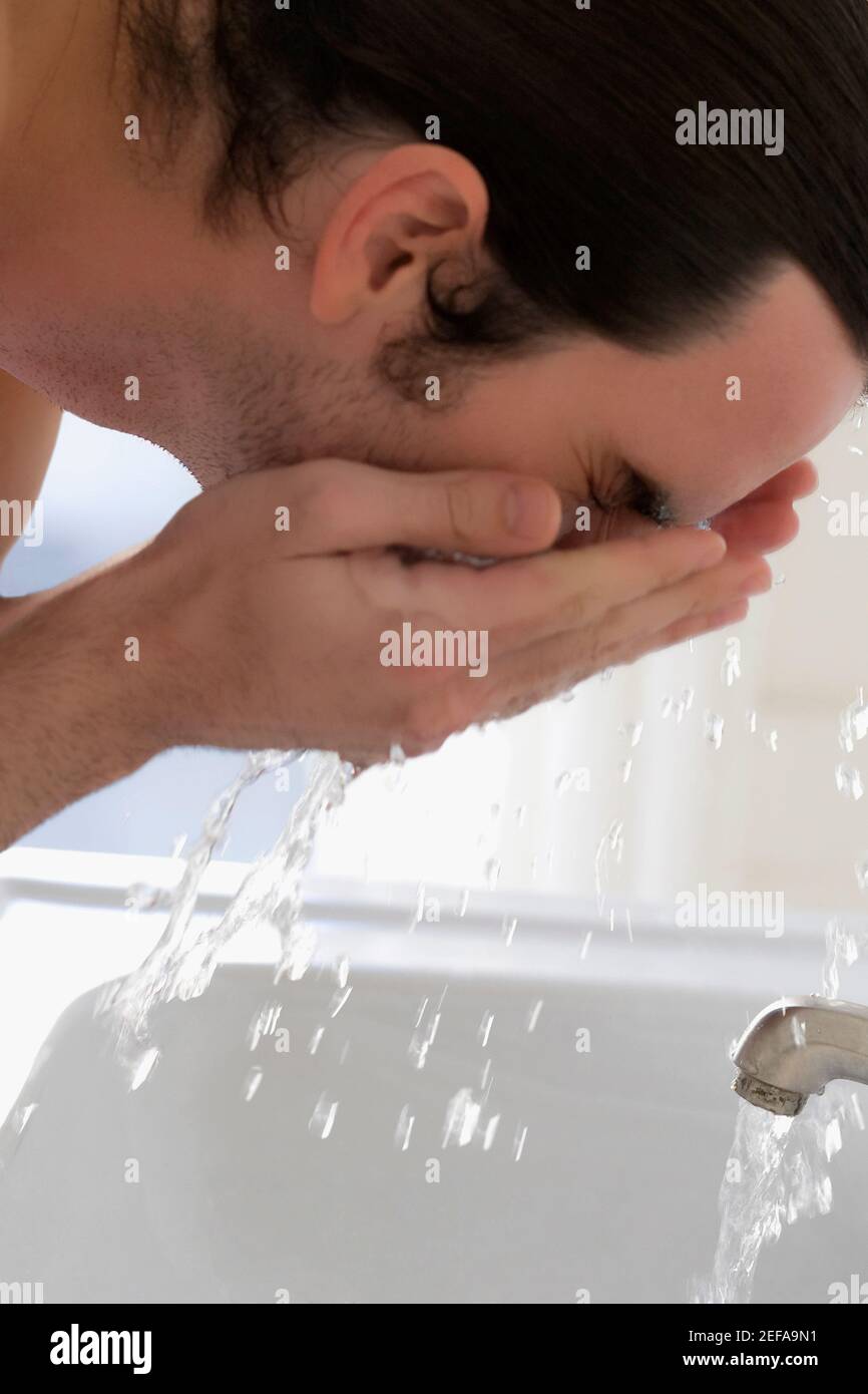 Close up of a young man washing his face Stock Photo - Alamy