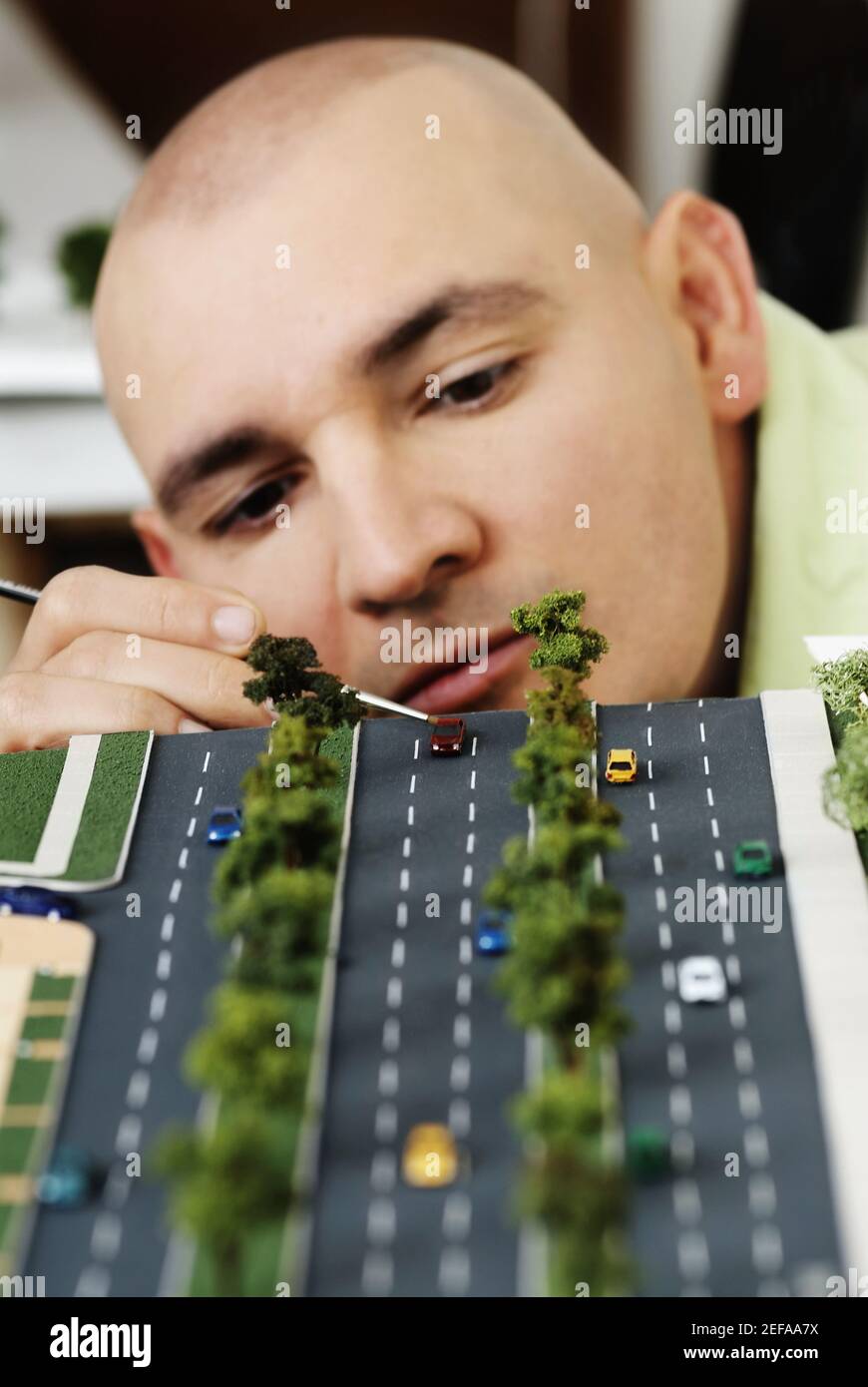 Male architect making an architectural model of a highway Stock Photo ...