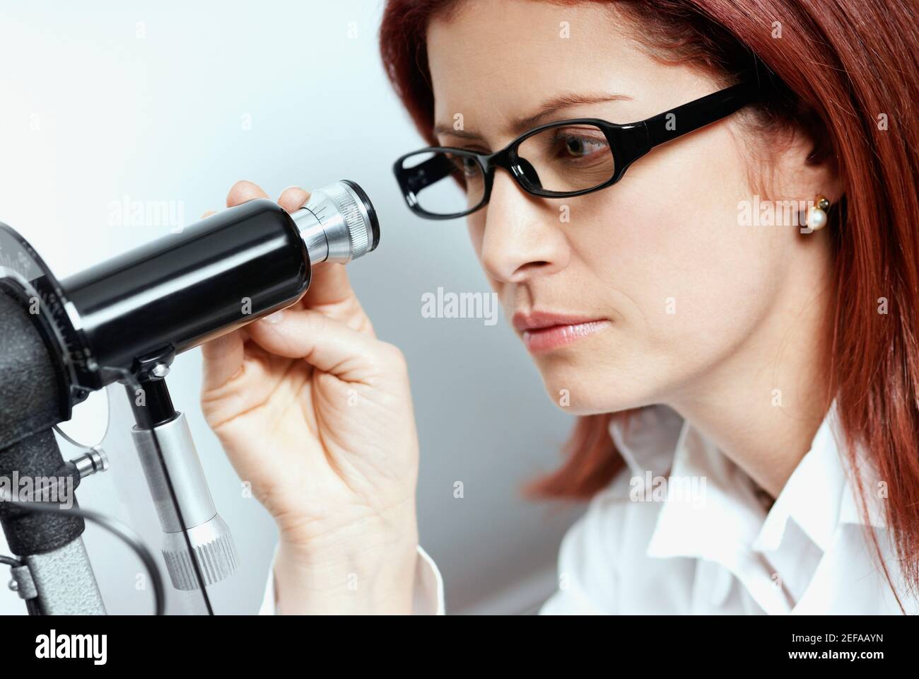 Close-up of a female optometrist using a phoropter Stock Photo - Alamy