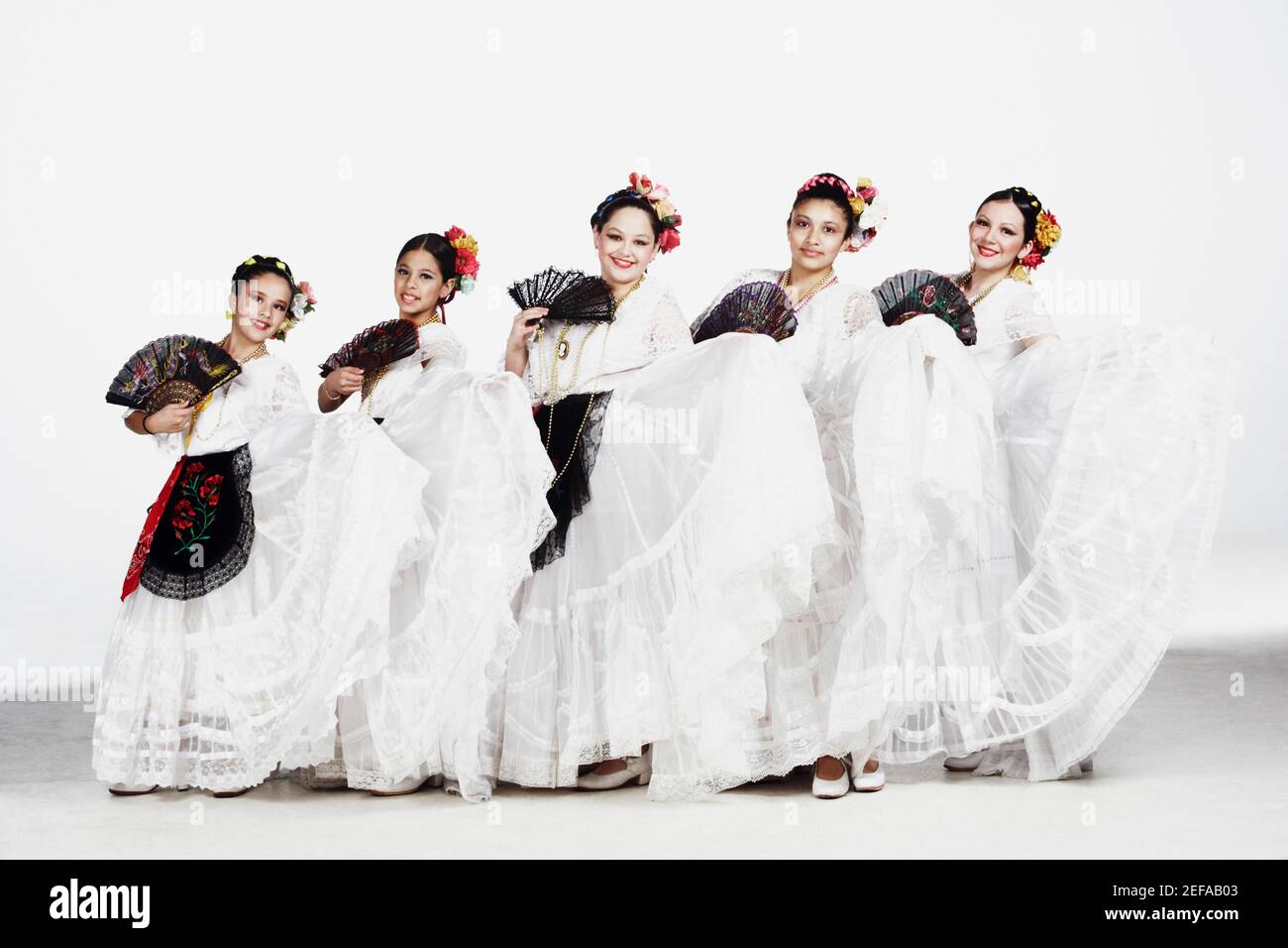 Portrait of a group of female dancers holding folding fans Stock Photo ...