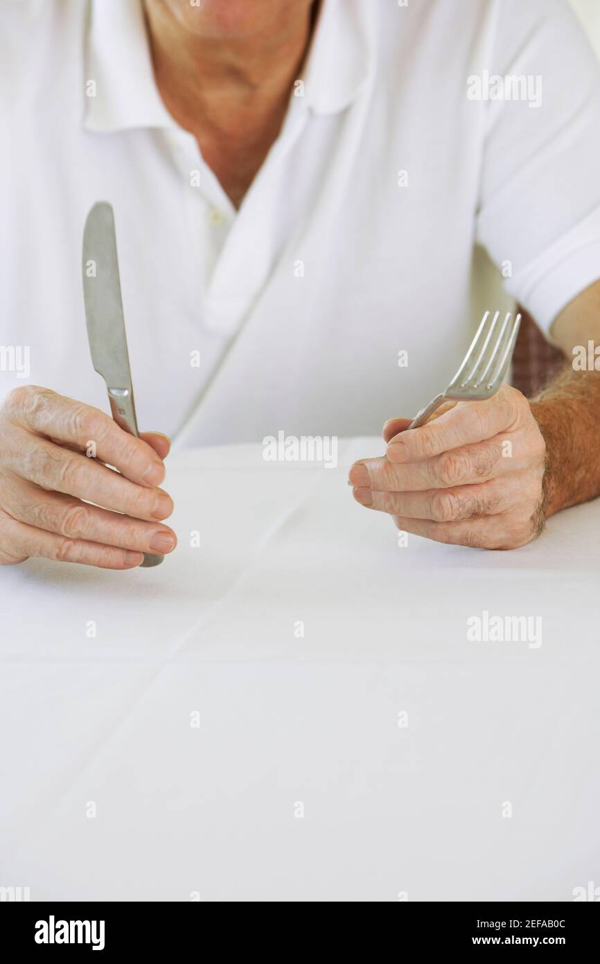 Human hand holding knife fork hi-res stock photography and images - Alamy