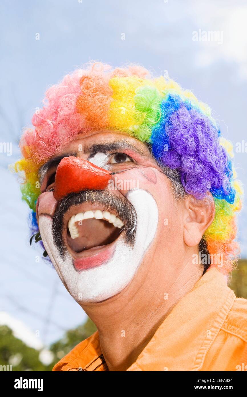 Close-up of a circus clown with a red nose and laughing Stock Photo - Alamy