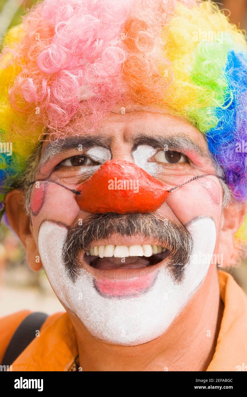 Close-up of a circus clown with a red nose and laughing Stock Photo - Alamy