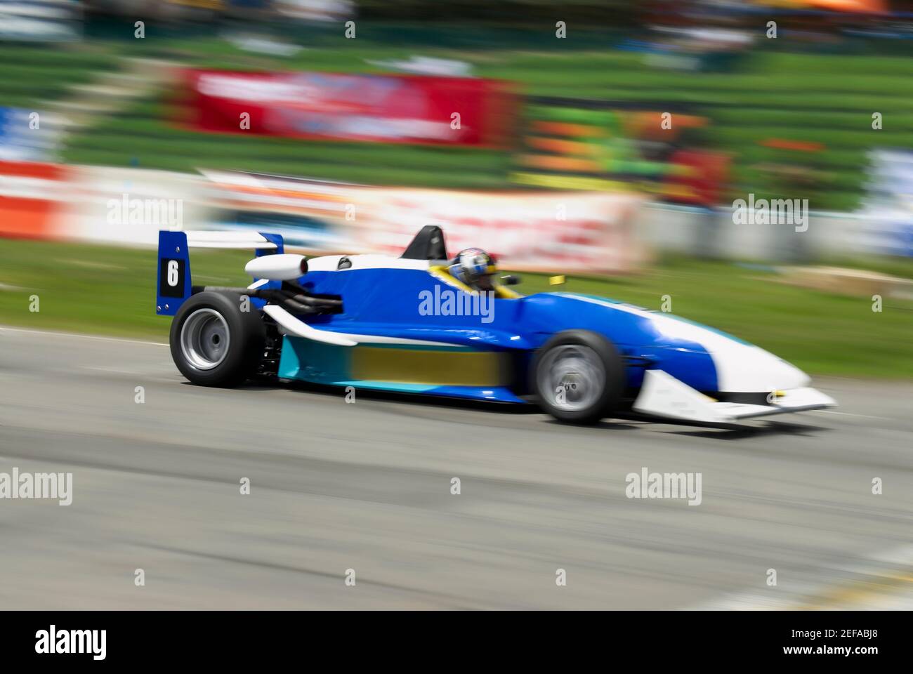 Racecar racing on a motor racing track Stock Photo - Alamy