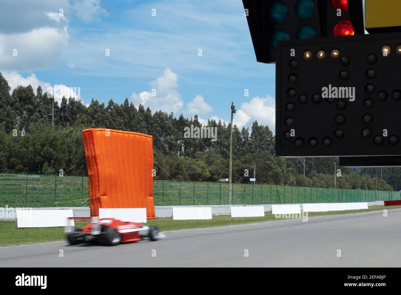 Racecar racing on a motor racing track Stock Photo - Alamy