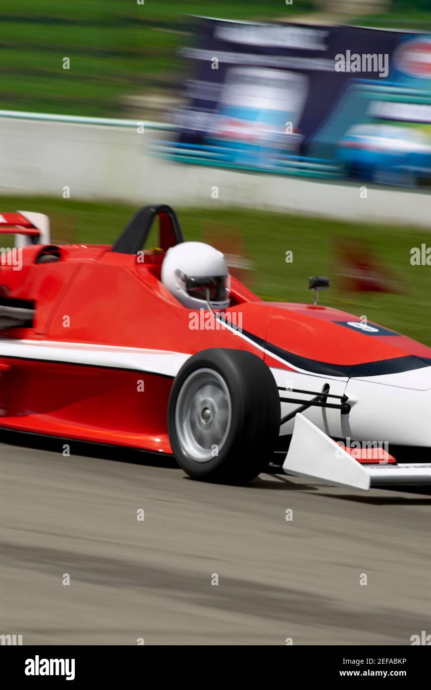 Racecar racing on a motor racing track Stock Photo - Alamy