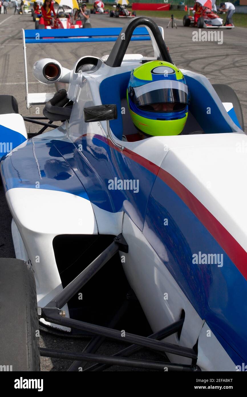 Racecar driver sitting in a racecar Stock Photo - Alamy