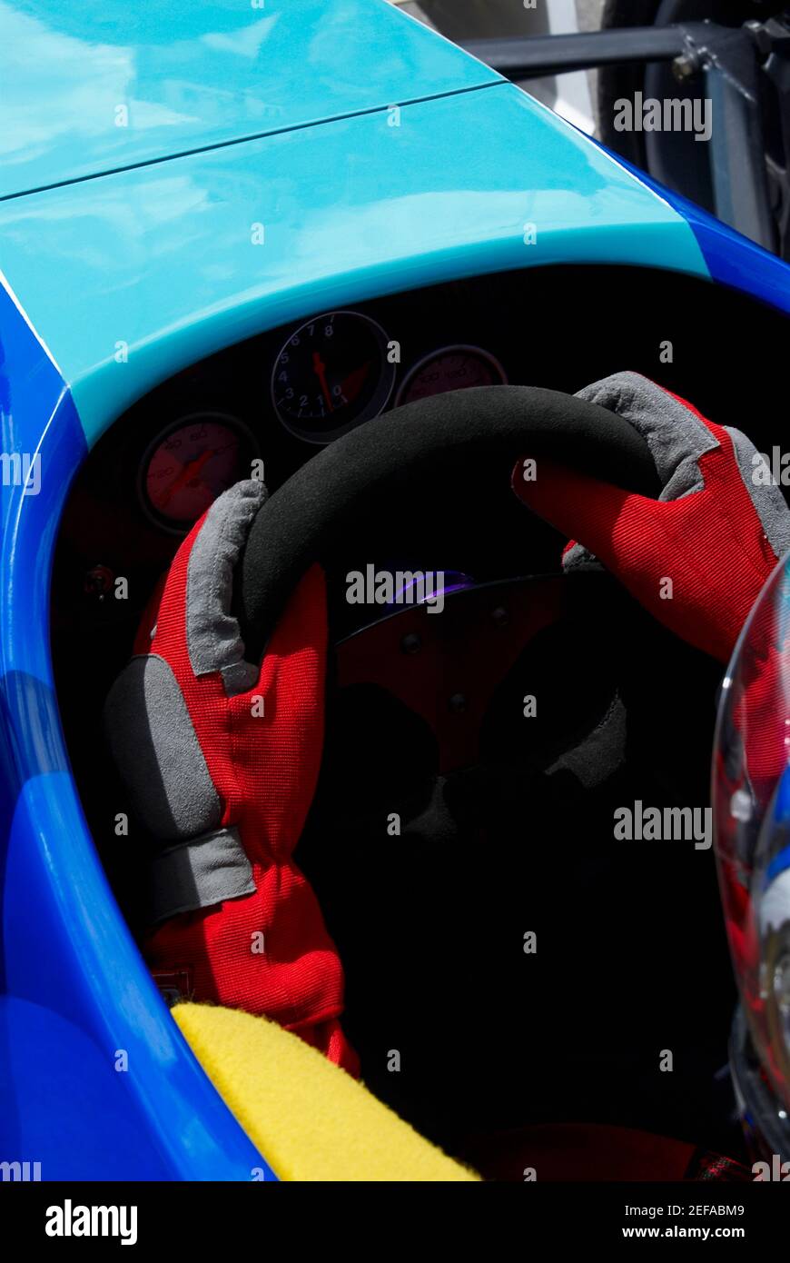 High angle view of a racecar driverÅ½s hands holding steering wheel of ...