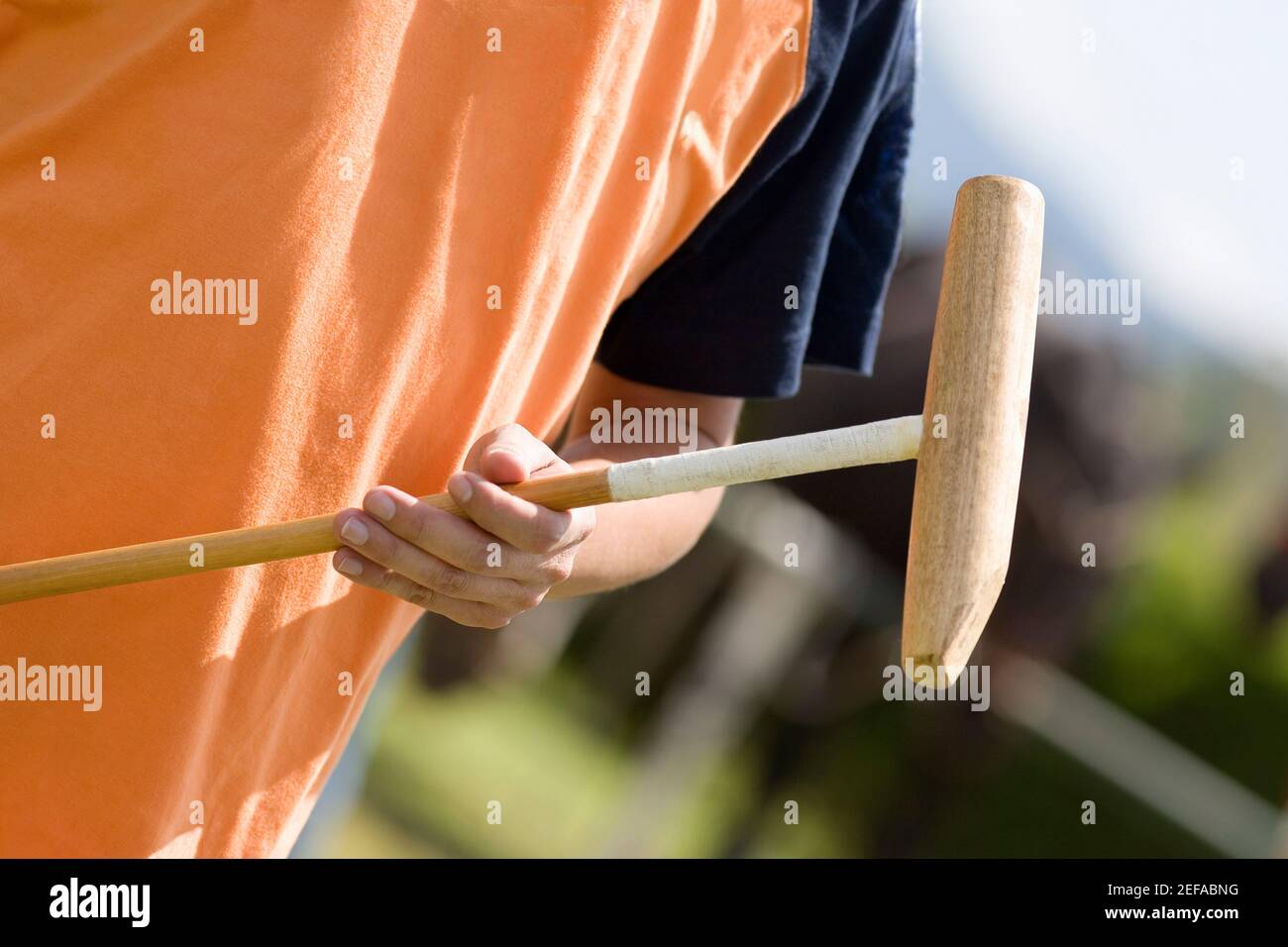Mid section view of a man holding a polo mallet Stock Photo - Alamy