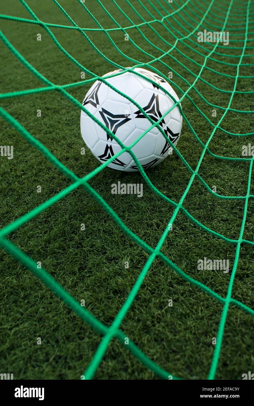 Close up of a soccer ball in a goal post net hi-res stock photography ...
