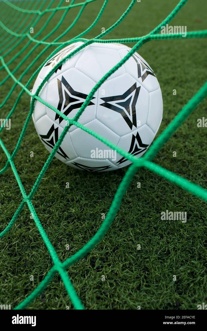 Close-up of a soccer ball in a goal post net Stock Photo - Alamy