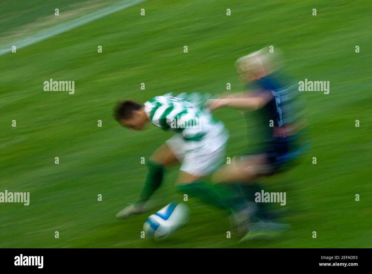 Two soccer players running ball hi-res stock photography and images - Alamy