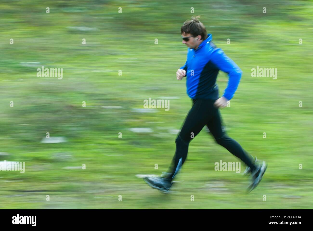 Side profile of a mid adult man jogging Stock Photo - Alamy