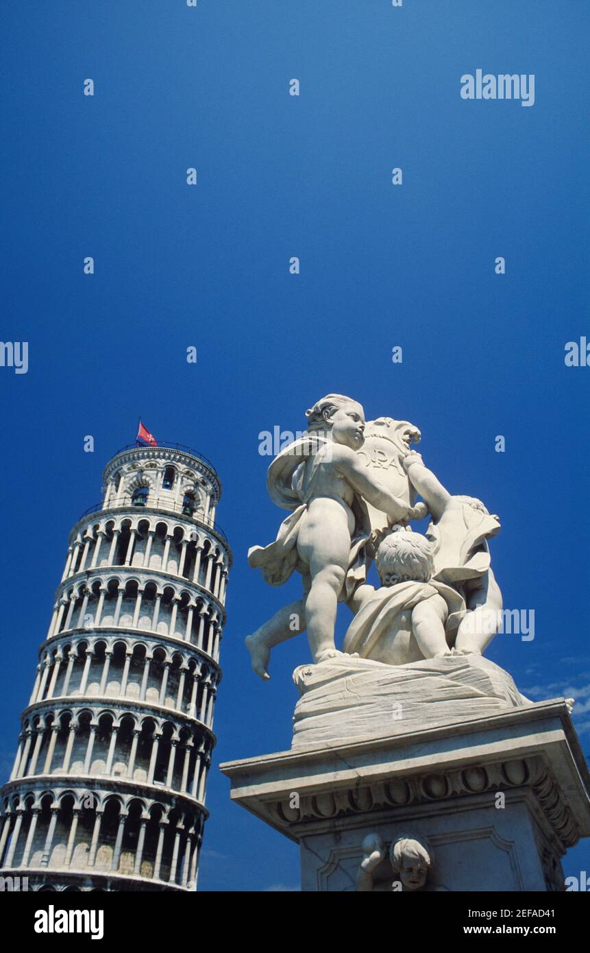 Low angle view of a statue in front of a tower, Leaning Tower of Pisa ...