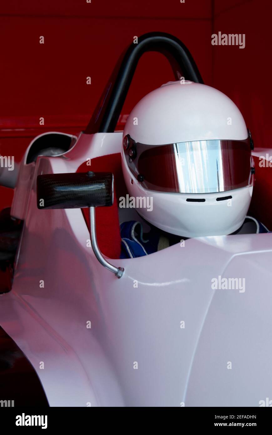 Driver in race car cockpit in red and white helmet hi-res stock ...