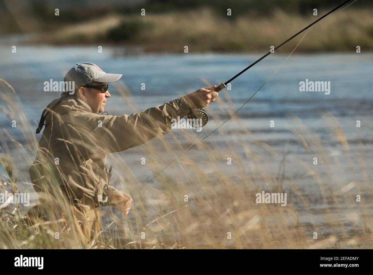 Side profile of a mature man fishing Stock Photo - Alamy
