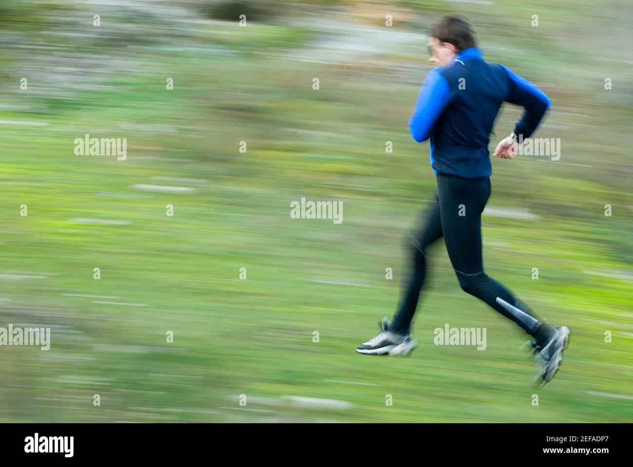 Side profile of a mid adult man running Stock Photo - Alamy