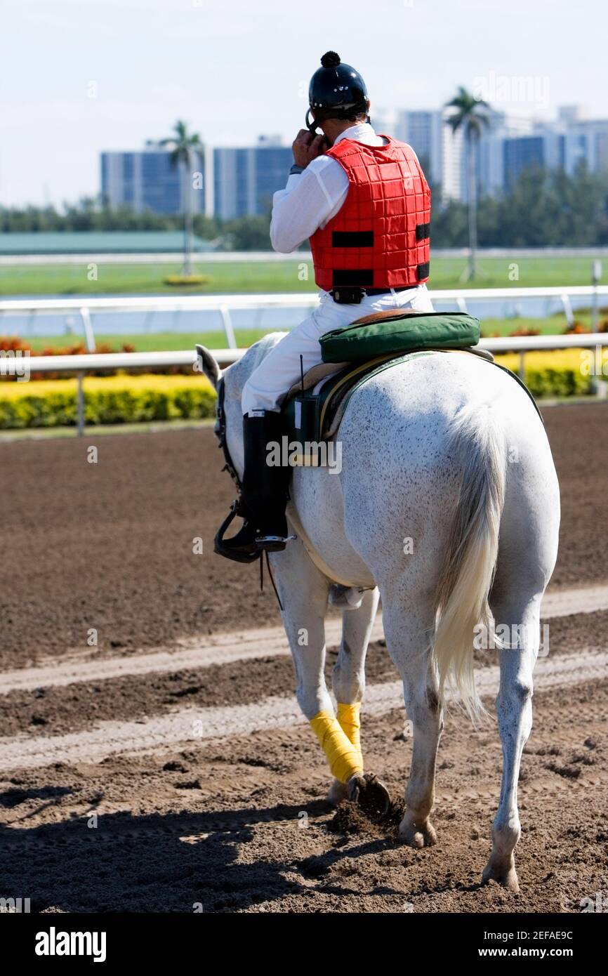 Rear view of a jockey riding a horse Stock Photo - Alamy