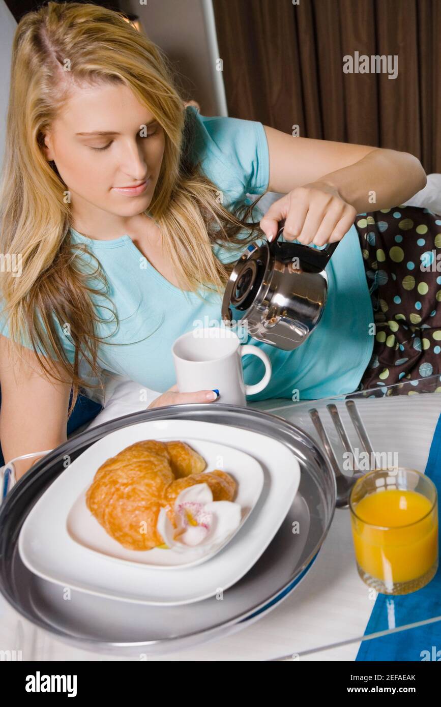 Woman pouring tea hi-res stock photography and images - Alamy