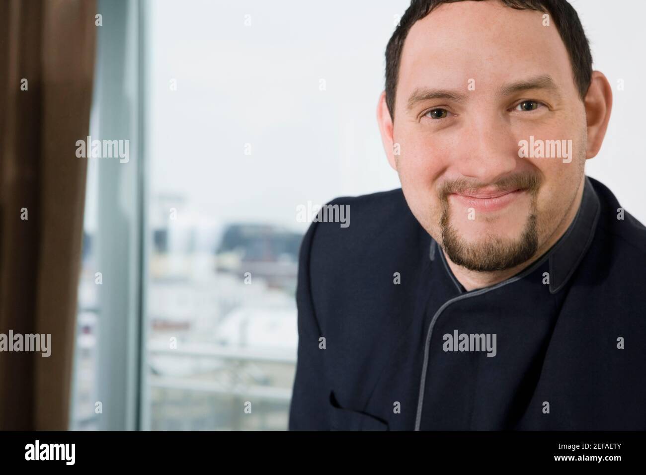 Portrait of a room service man smiling Stock Photo - Alamy