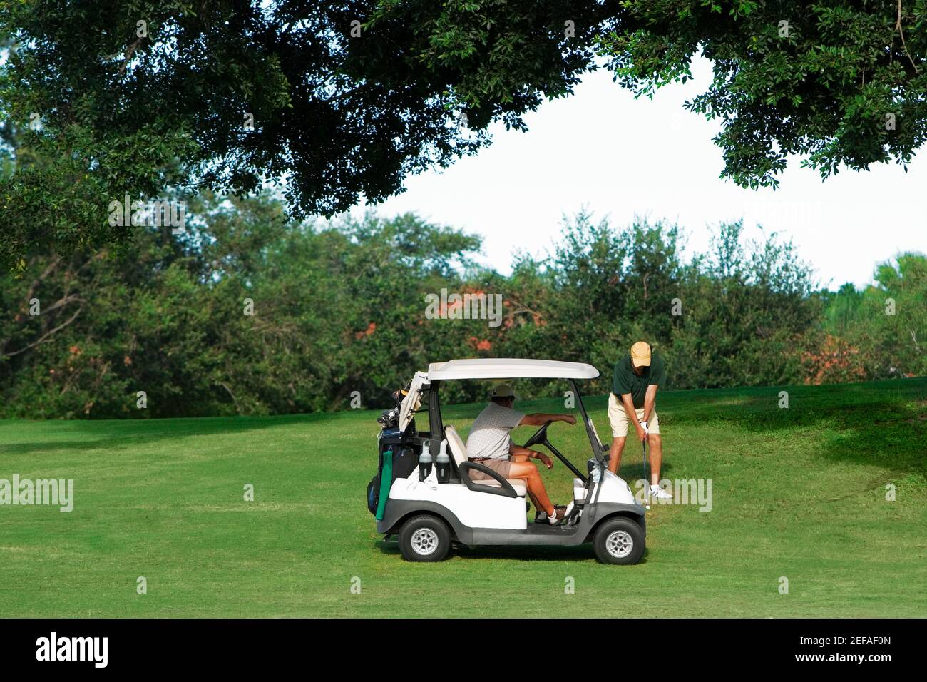Two men playing golf in a golf course Stock Photo - Alamy