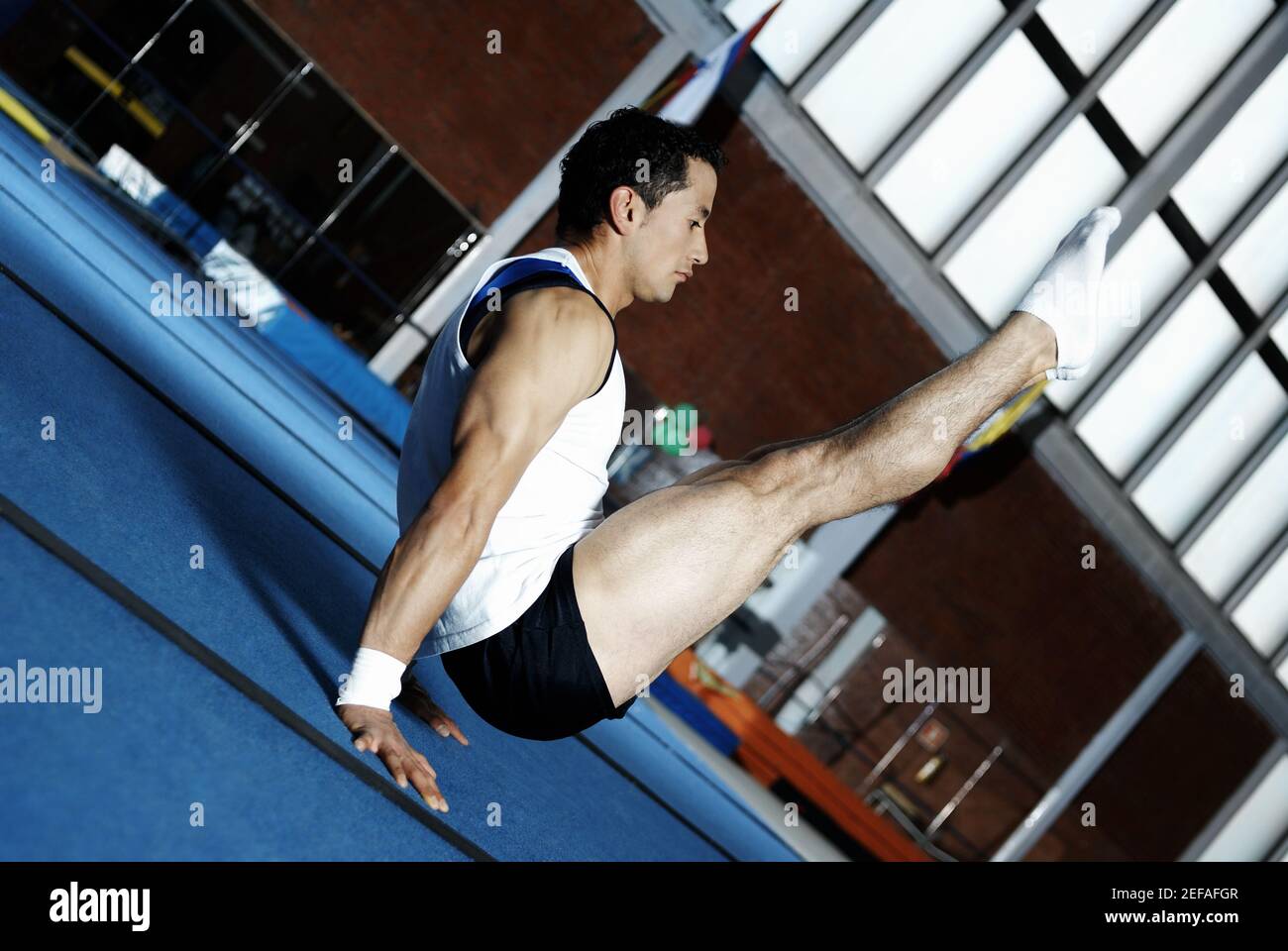 Side profile of a male gymnast balancing on his hands Stock Photo - Alamy
