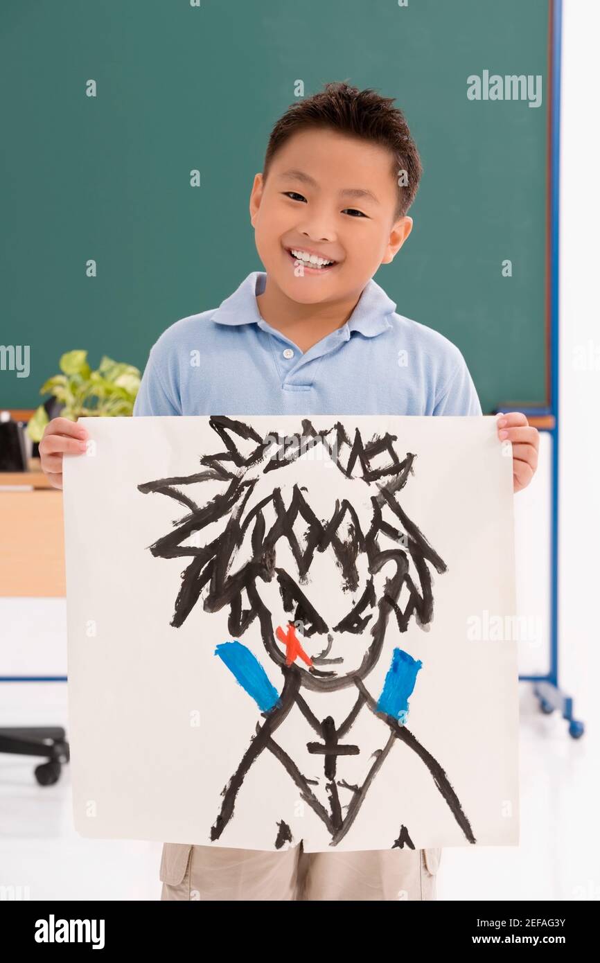 Portrait of a schoolboy showing his drawing and smiling Stock Photo - Alamy