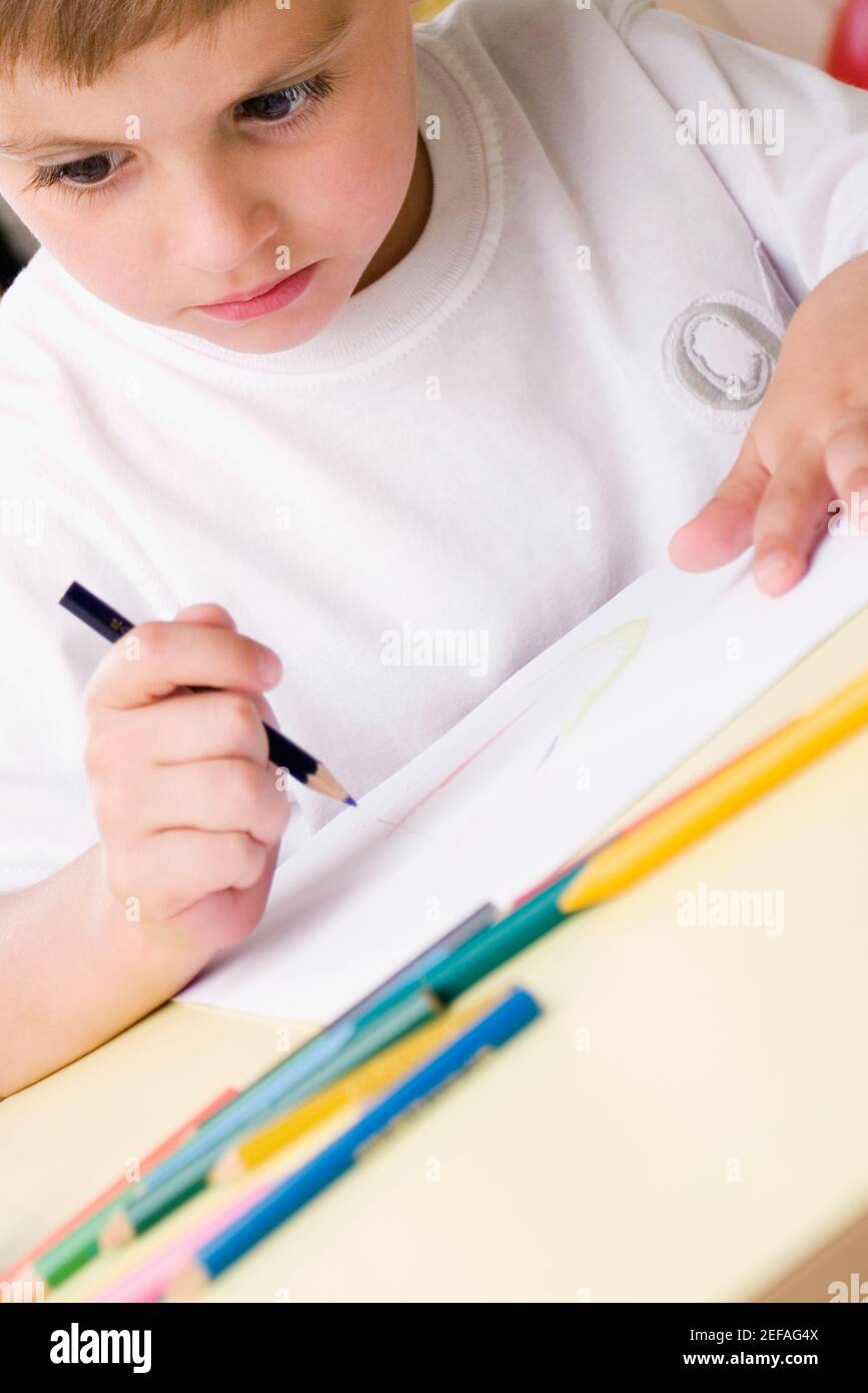 Close up of a boy drawing on a sheet of paper Stock Photo - Alamy