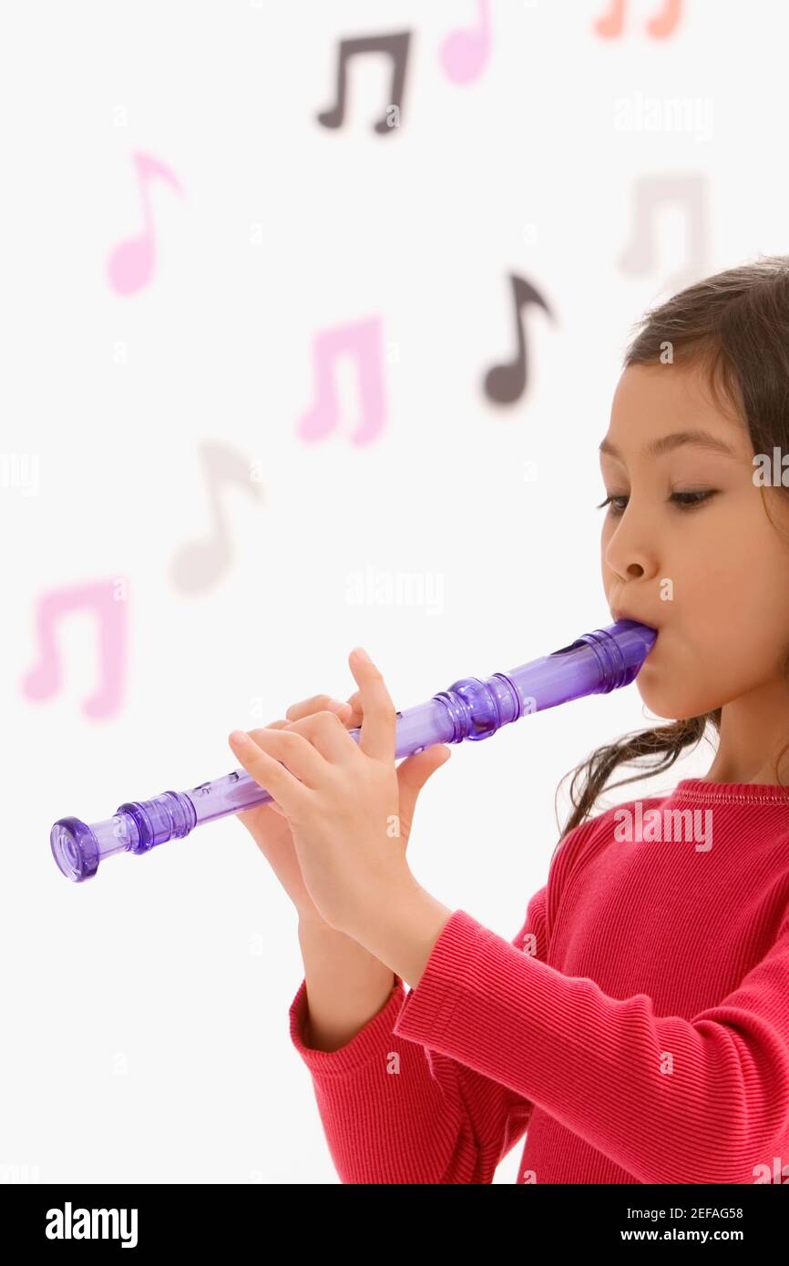 Side profile of a schoolgirl playing a flute in a classroom Stock Photo ...