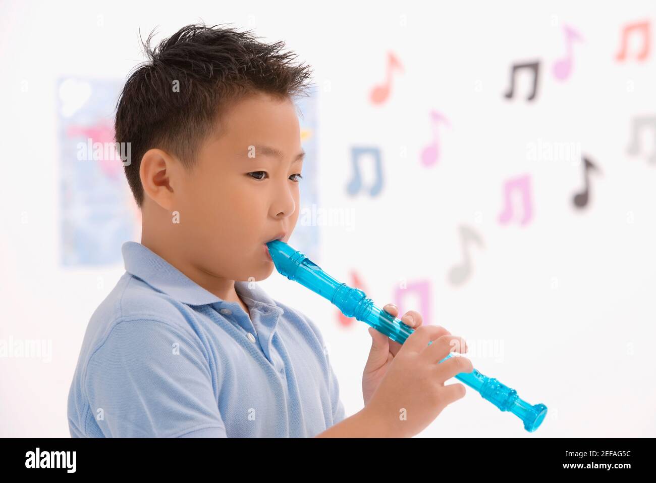 Side profile of a schoolboy playing a flute Stock Photo - Alamy