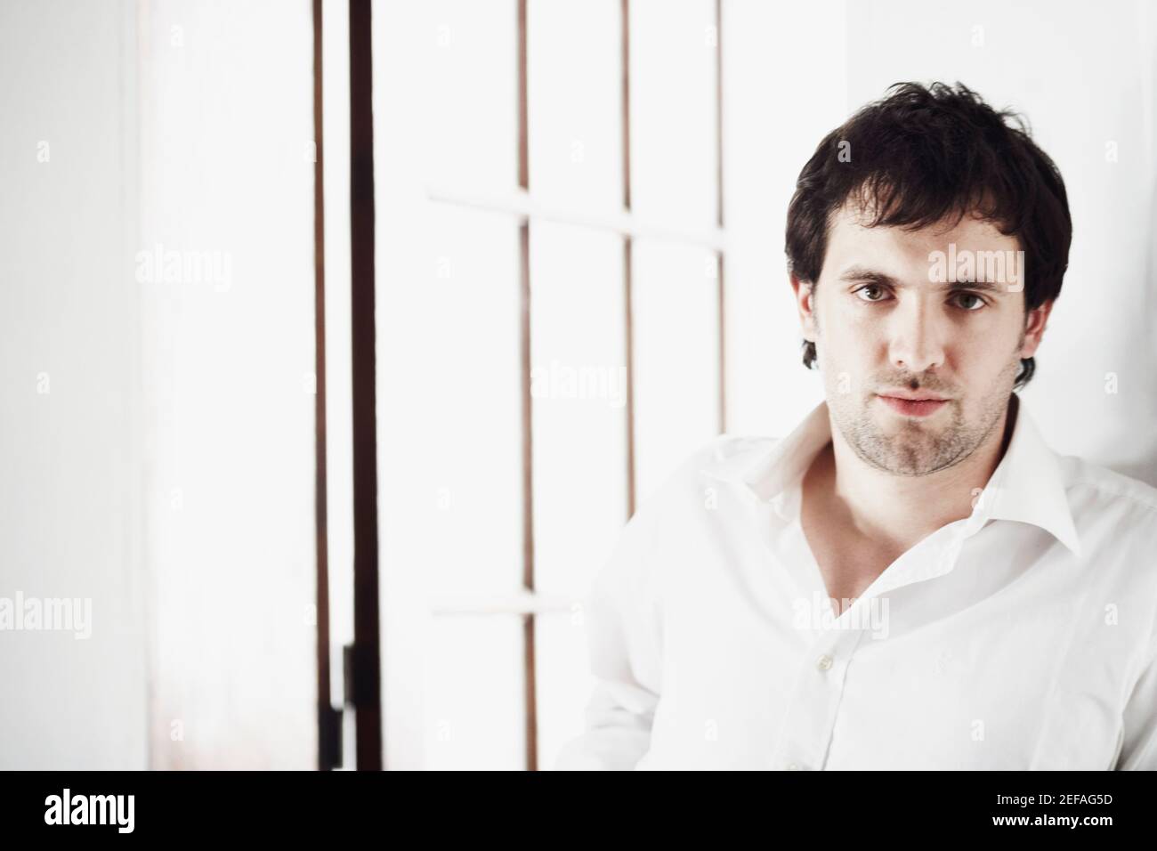 Close-up of a young man looking serious Stock Photo - Alamy