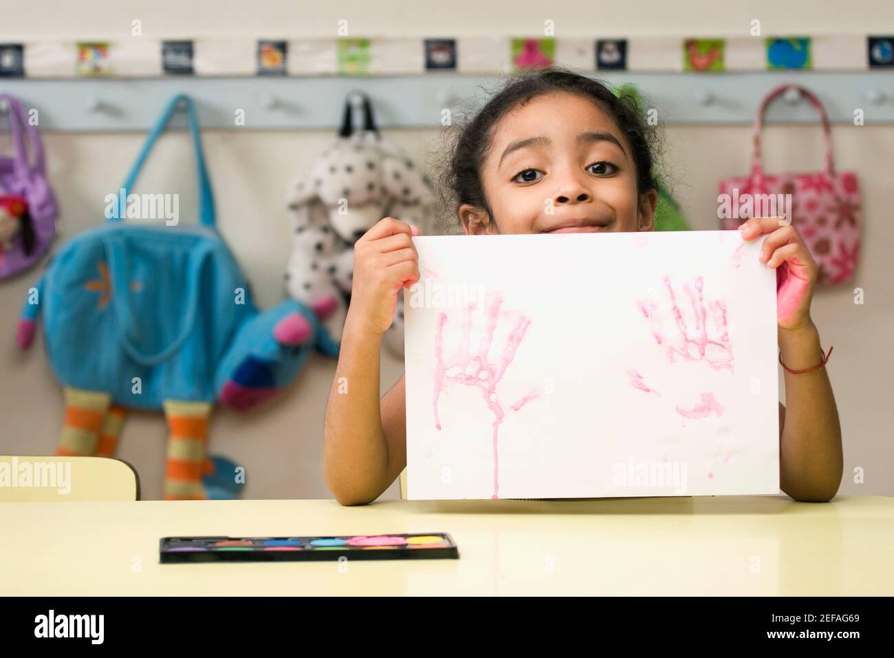 Portrait of a girl showing a drawing Stock Photo - Alamy