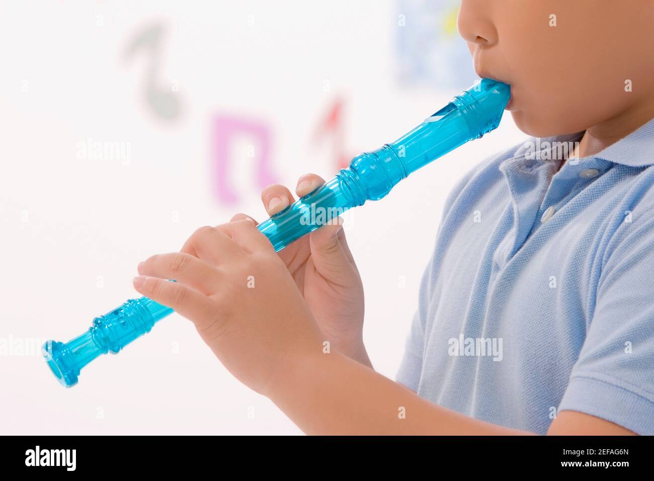 Side profile of a schoolboy playing a flute Stock Photo - Alamy