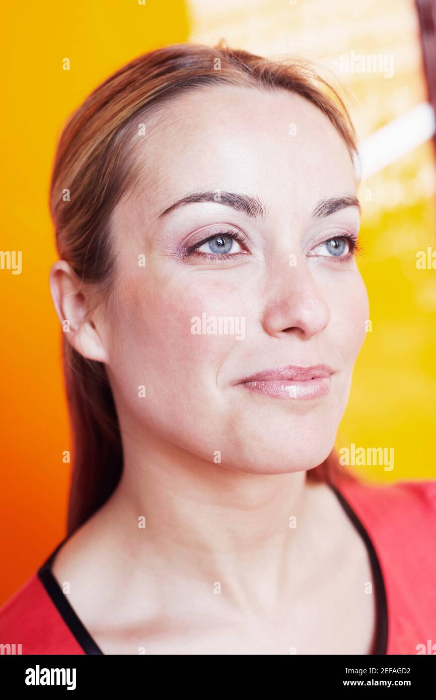 Close-up of a young woman smirking Stock Photo - Alamy