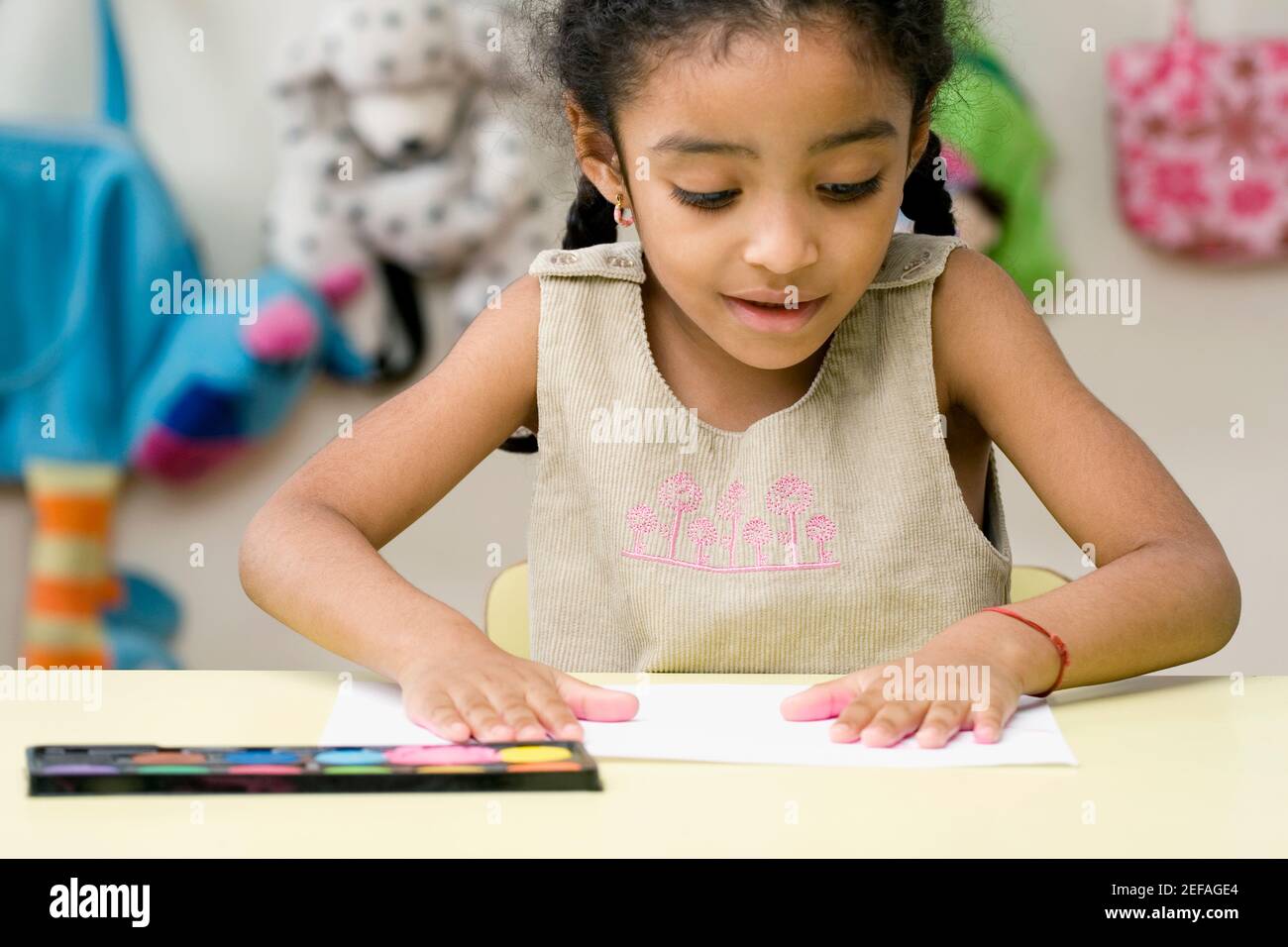 GirlÅ½s hands printing on a sheet of paper Stock Photo - Alamy