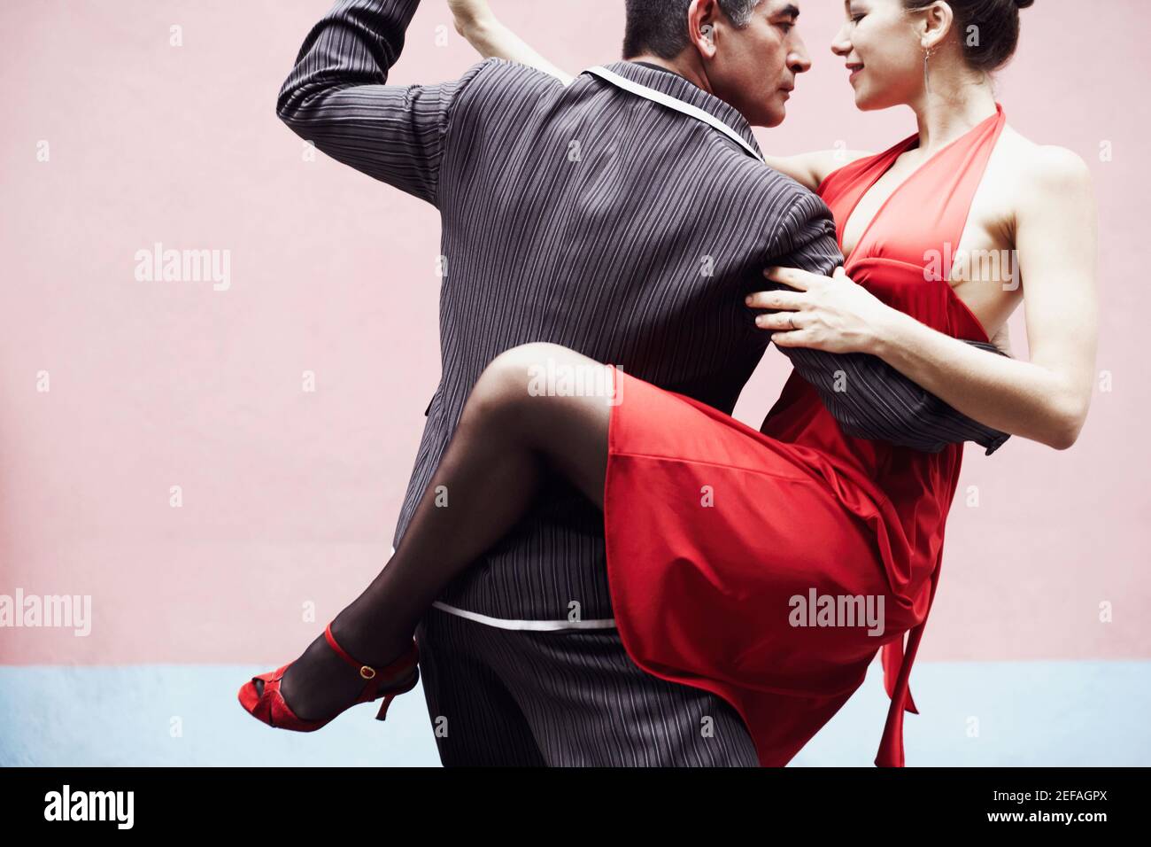 Mature man and a mid adult woman tangoing Stock Photo - Alamy