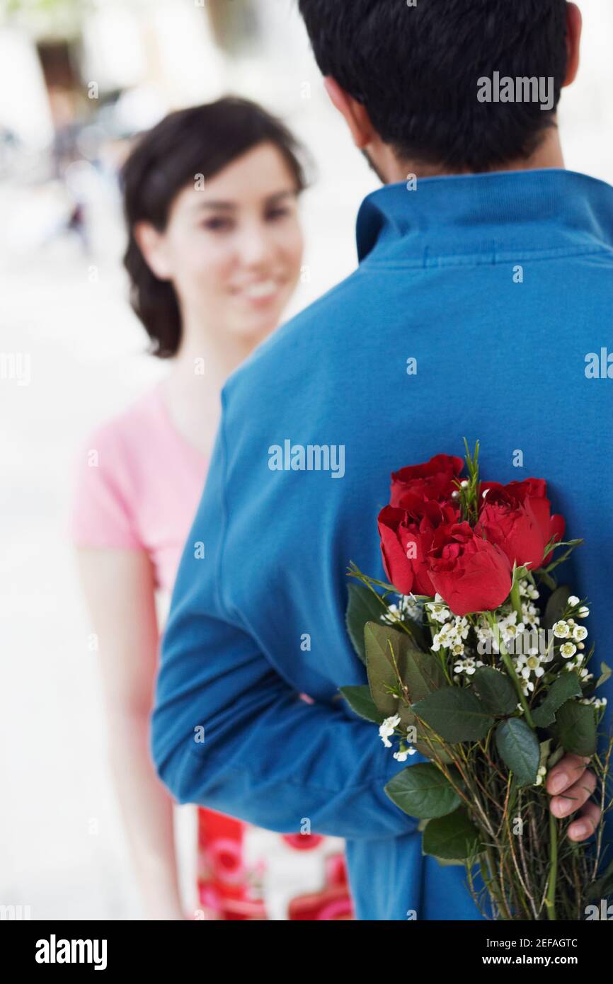 Man hiding rose behind back hi-res stock photography and images - Alamy