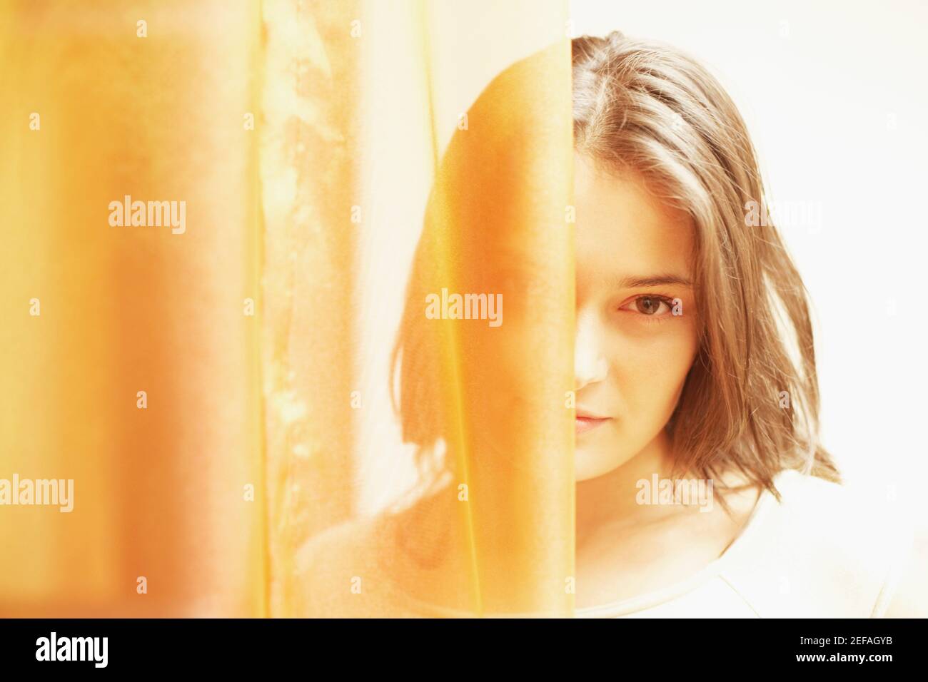 Woman behind a curtain hi-res stock photography and images - Alamy