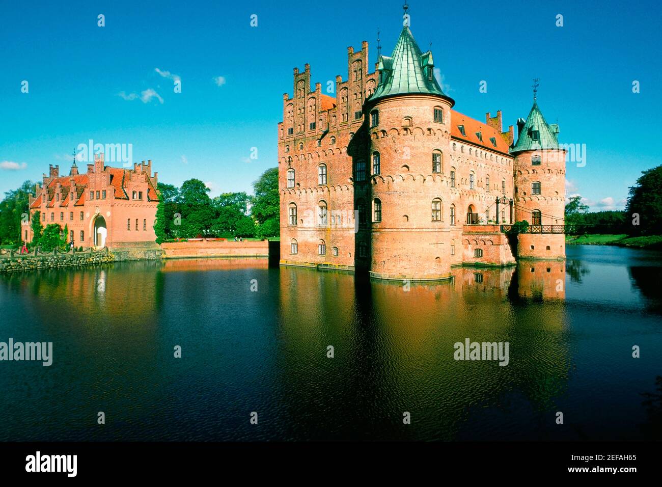 Reflection of a castle in water, Egeskov Castle, Funen County, Denmark ...