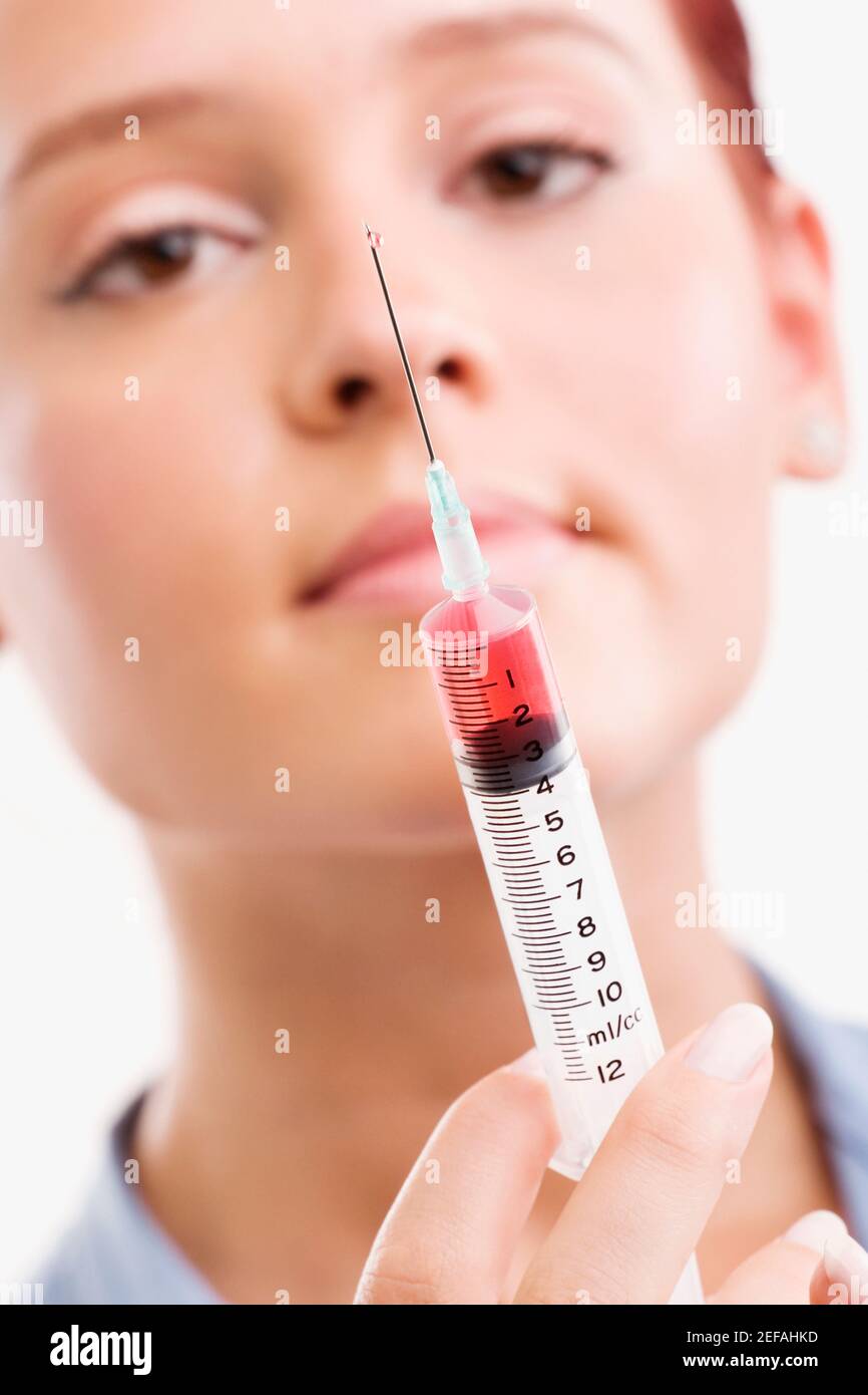 Doctor holding a syringe hi-res stock photography and images - Alamy