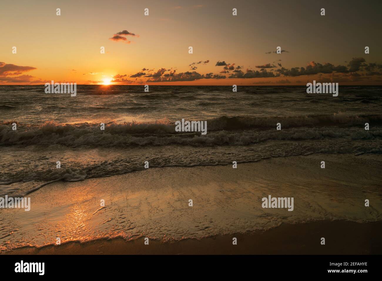 Beach by the ocean with waves at sunset as a header background Stock ...