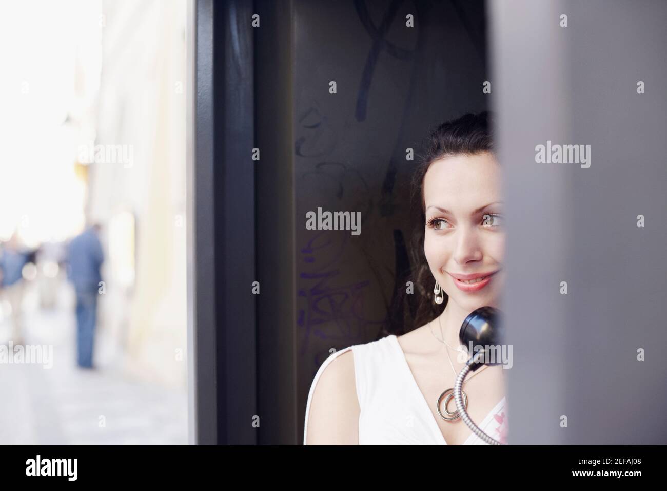 Young woman in a telephone booth Stock Photo - Alamy