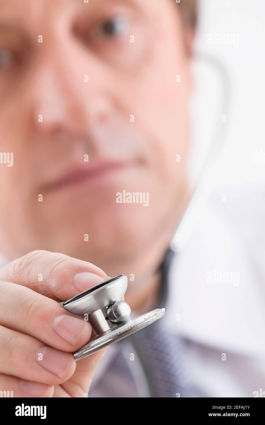Close up of a male doctor holding a stethoscope Stock Photo - Alamy