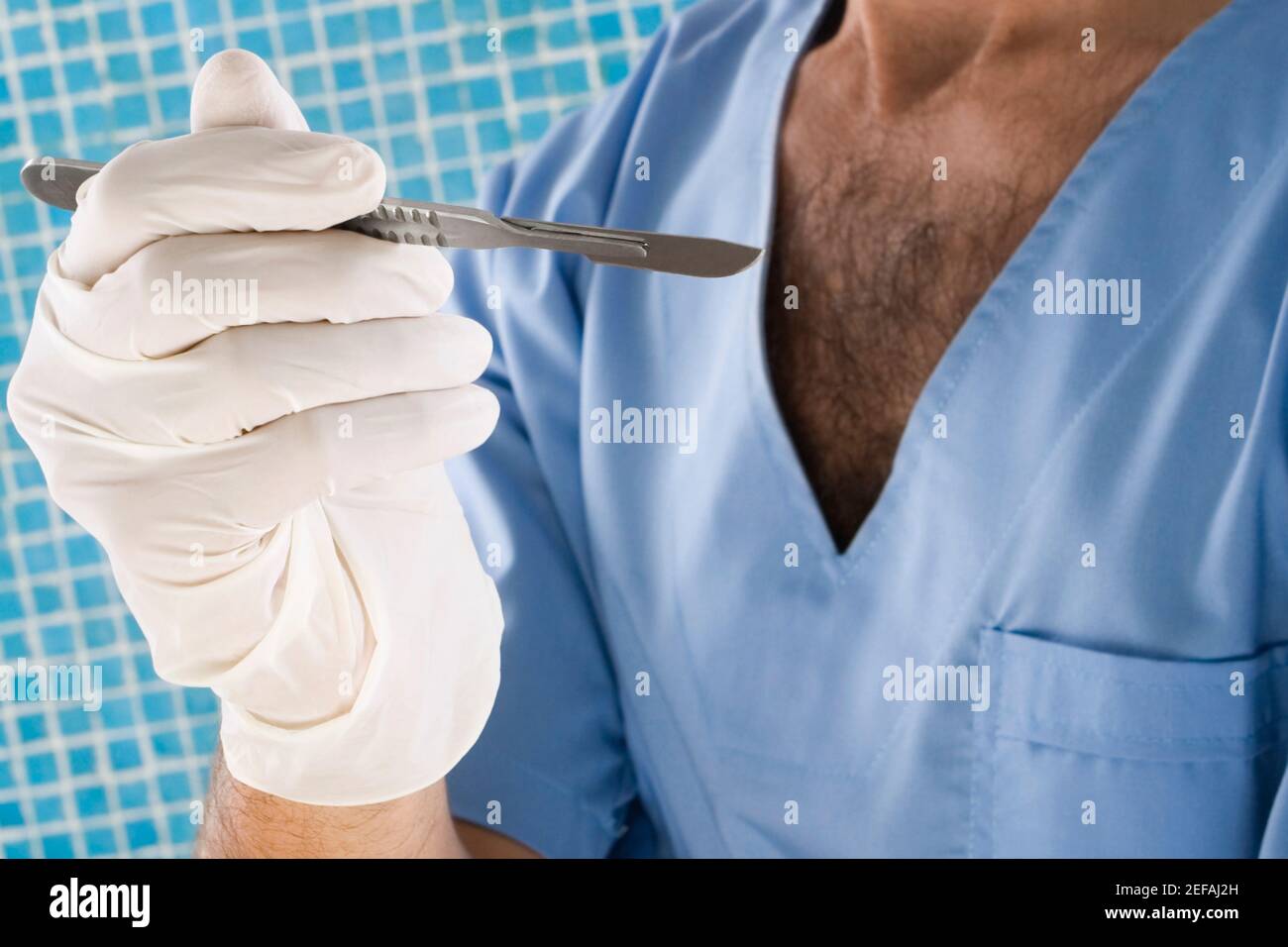 Mid section view of a male surgeon holding a scalpel Stock Photo - Alamy