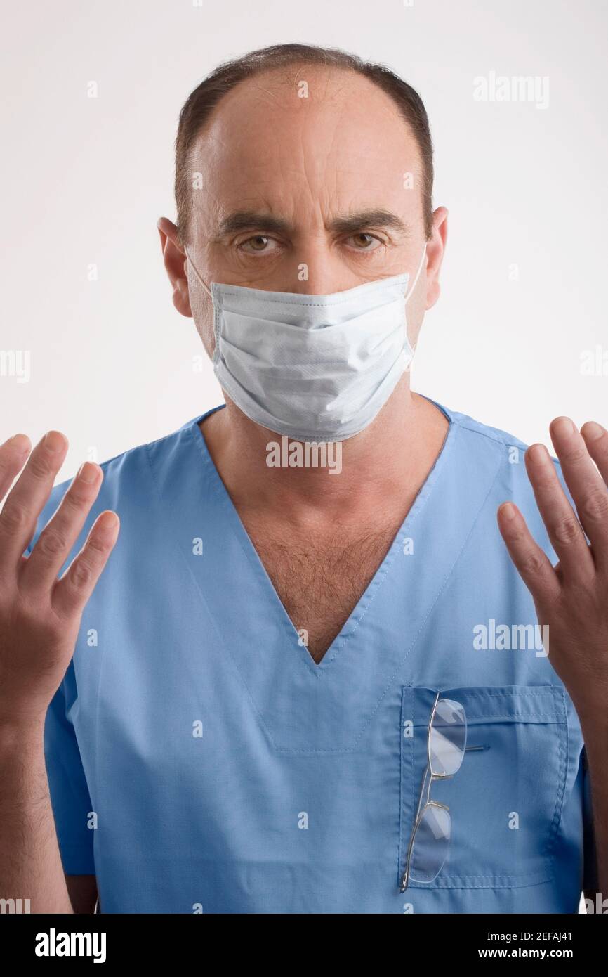 Portrait of a male surgeon with his arms raised Stock Photo - Alamy