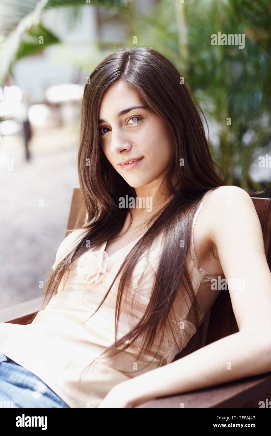 Portrait of a young woman sitting Stock Photo - Alamy
