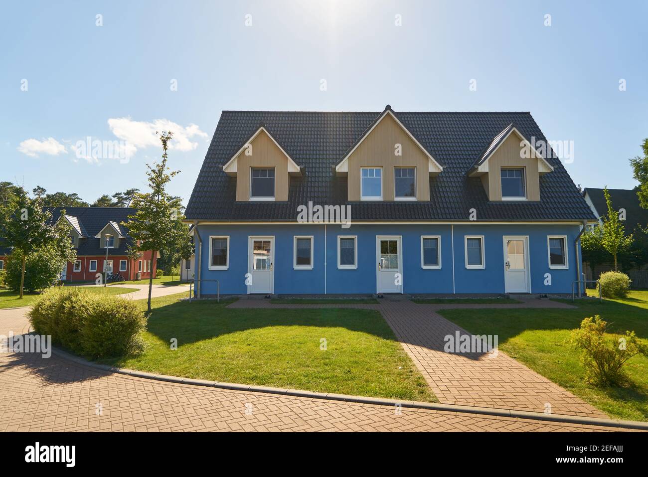 Blue house with garden in summer in an idyllic village Stock Photo - Alamy