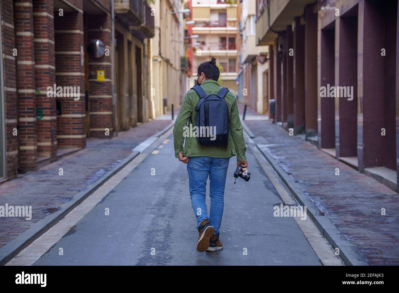 Tourist man with a backpack walking in the streets of the city Stock ...