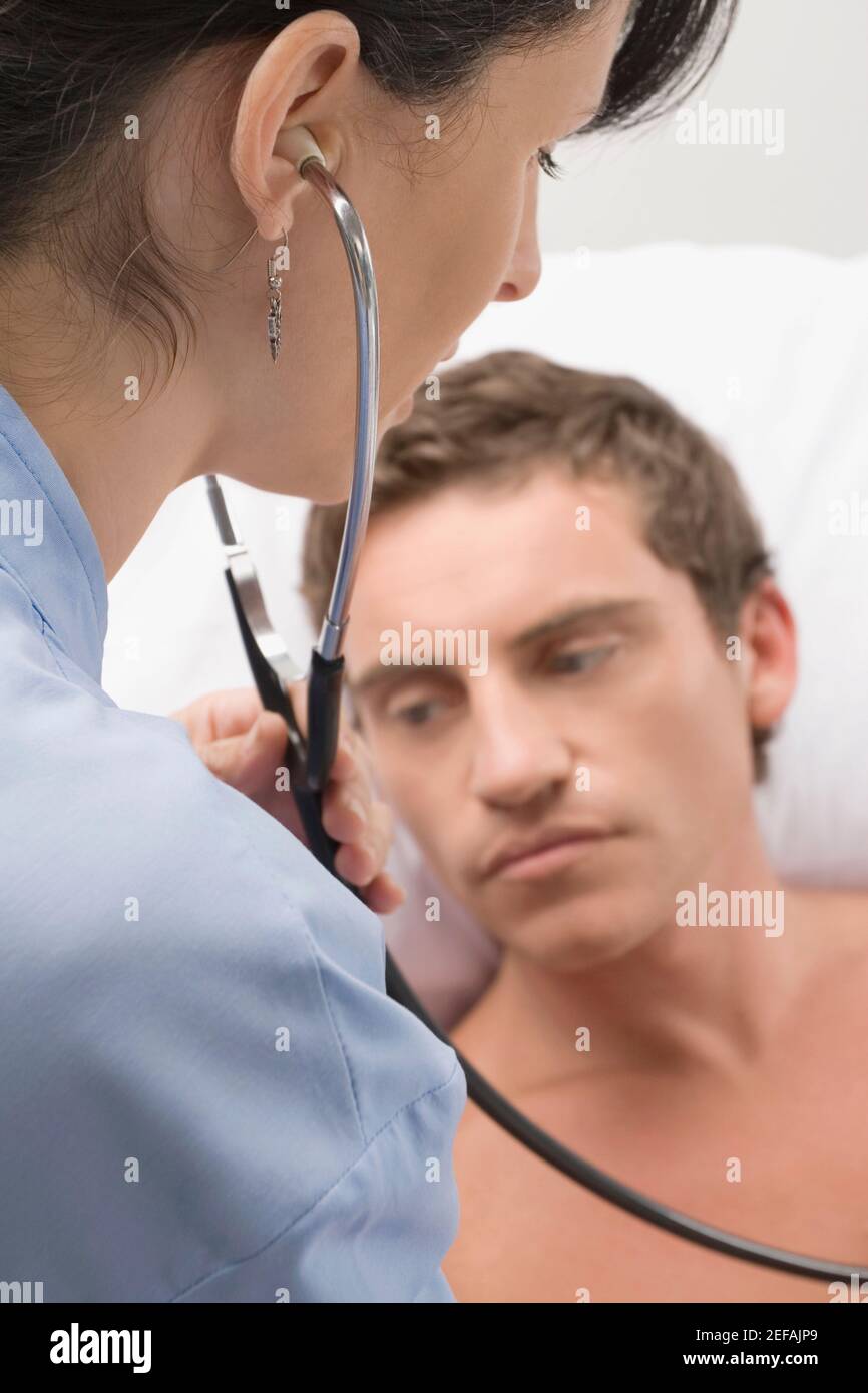 Female surgeon examining a mid adult man Stock Photo - Alamy