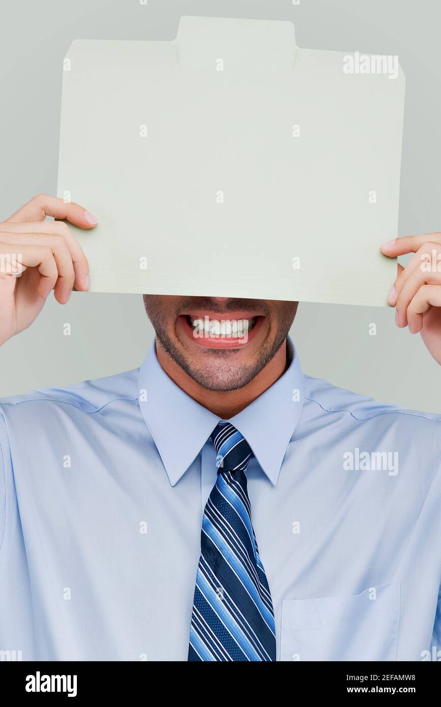 Close up of a businessman holding a placard in front of his face Stock ...